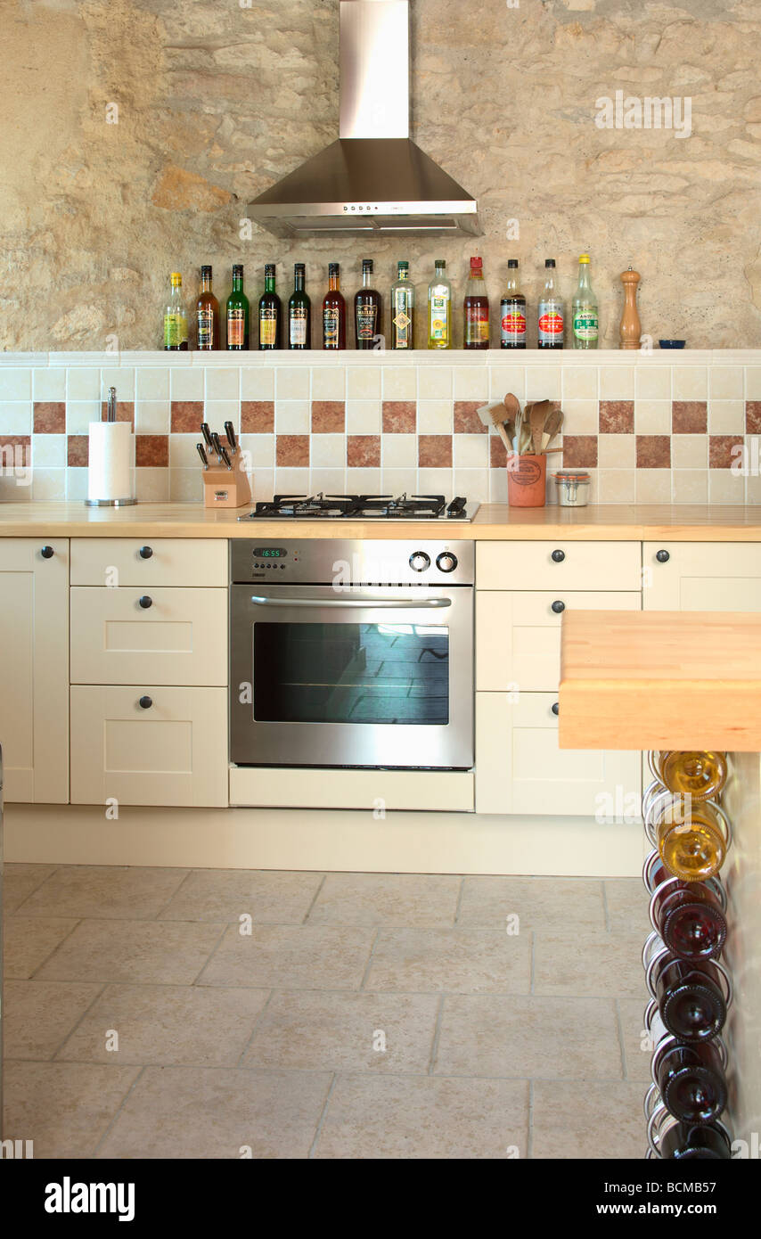 Stainless steel extractor hood above tiled splash-back and stainless ...