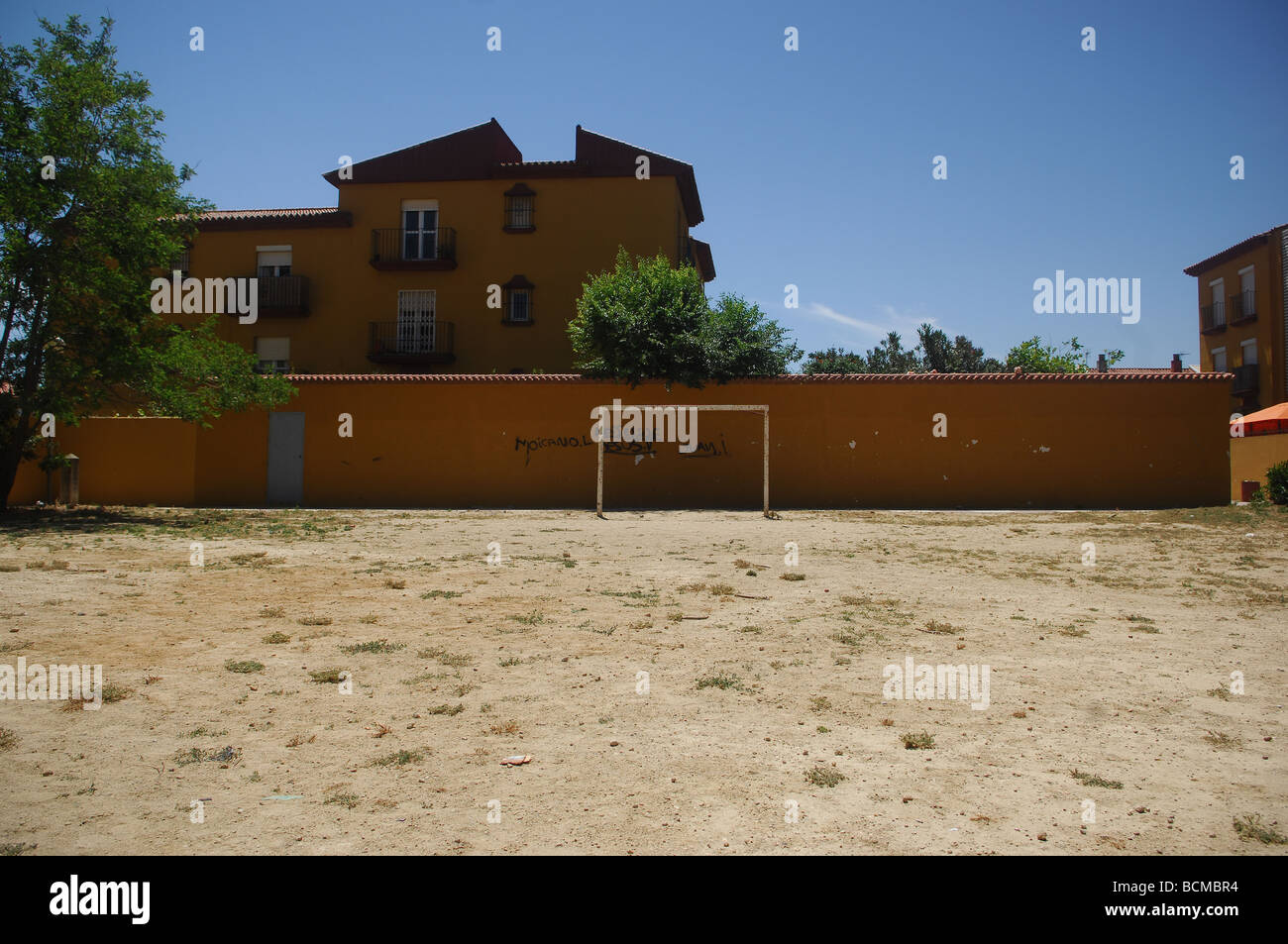 A rough, dirt football pitch with the Rock of Gibraltar in the ...