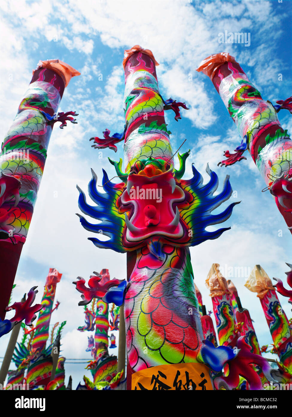 three giant jossticks in front of many behind Stock Photo - Alamy