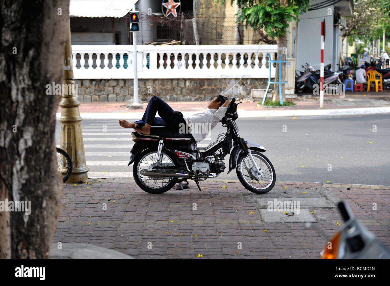 Man sleeping on motorbike hi-res stock photography and images - Alamy
