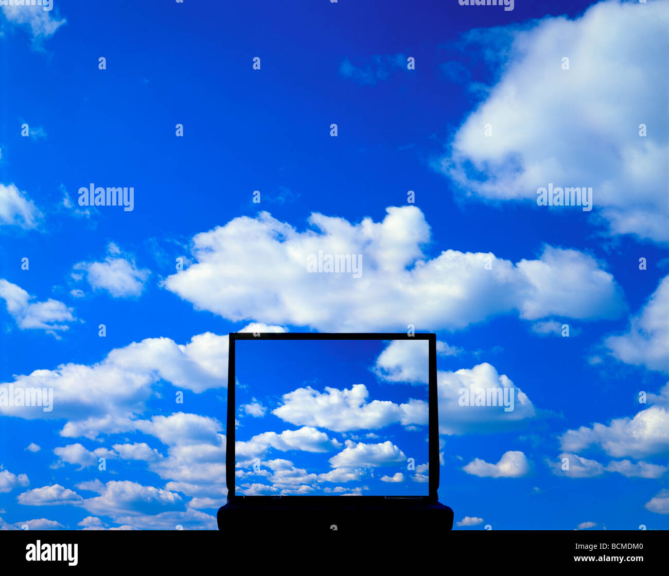 laptop computer with fluffy white clouds on monitor with same clouds in ...