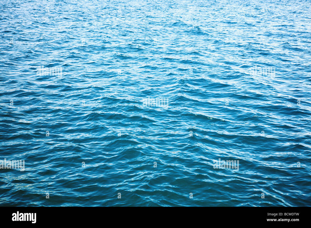 Azure sea water surface with ripple and cloud reflections Stock Photo ...