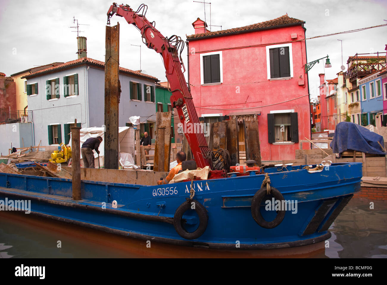 Italy Veneto Burano Workboat installs steel girder in canal to brace up ...