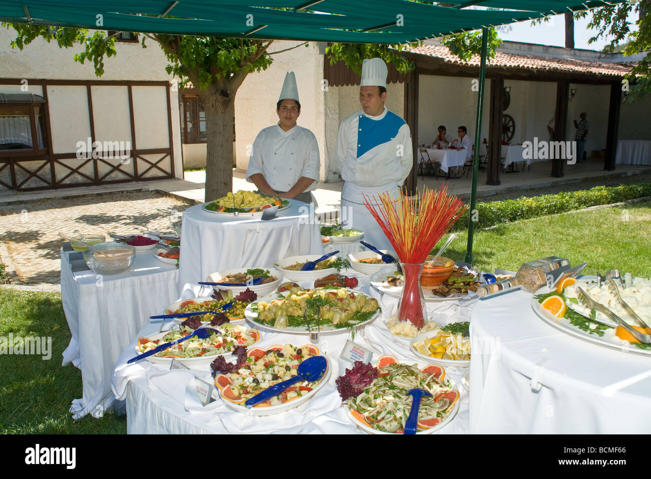 Outdoor buffet for tourists Artemis Restaurant. Old Greek school ...