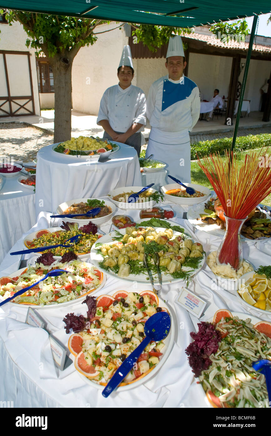 Outdoor buffet for tourists Artemis Restaurant. Old Greek school ...
