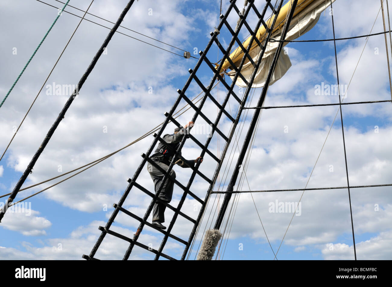 Sailor climbing ships shroud to mast Stock Photo - Alamy