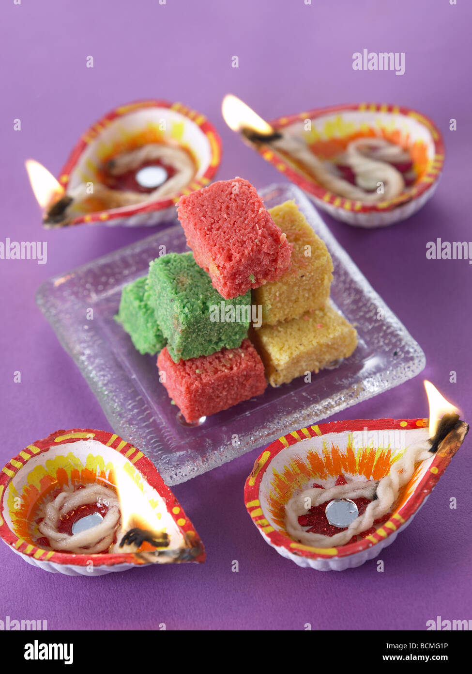 a plate of indian candies with oil lamps Stock Photo - Alamy