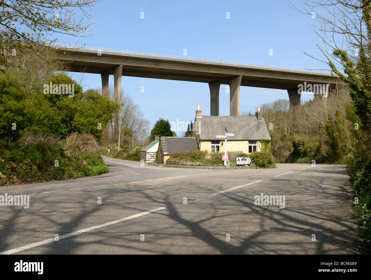 Small house sits under a motorway flyover Stock Photo - Alamy