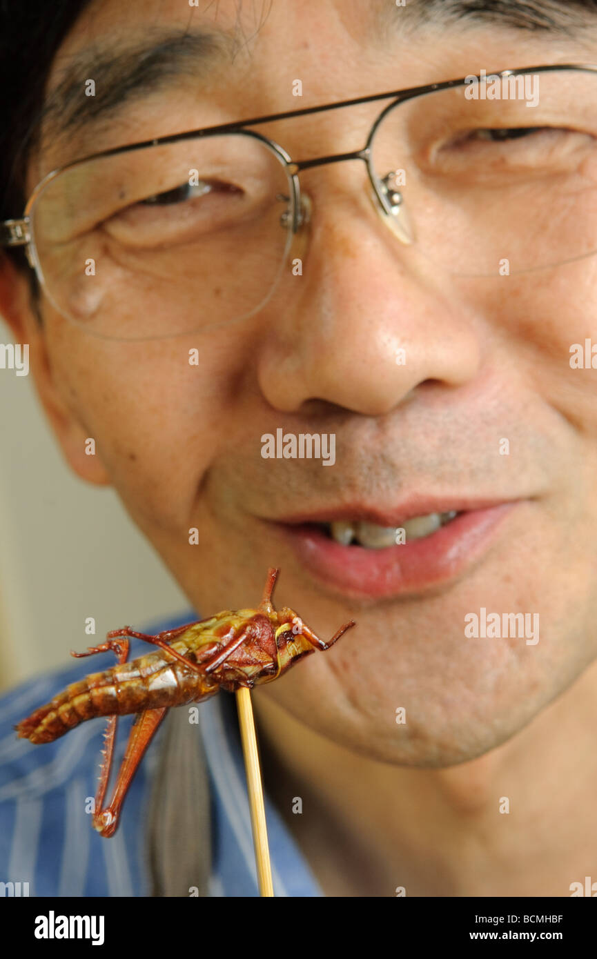 Shoichi Uchiyama eating a locust, Tokyo, Japan, 28 October, 2008 Stock ...