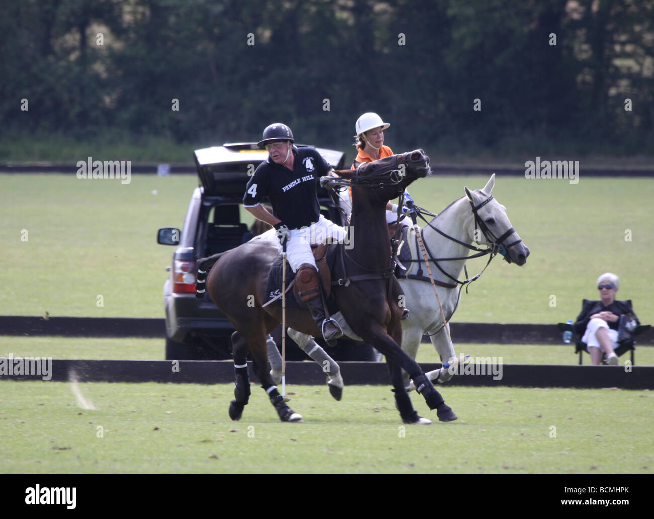 Polo players chasing after the ball Stock Photo - Alamy