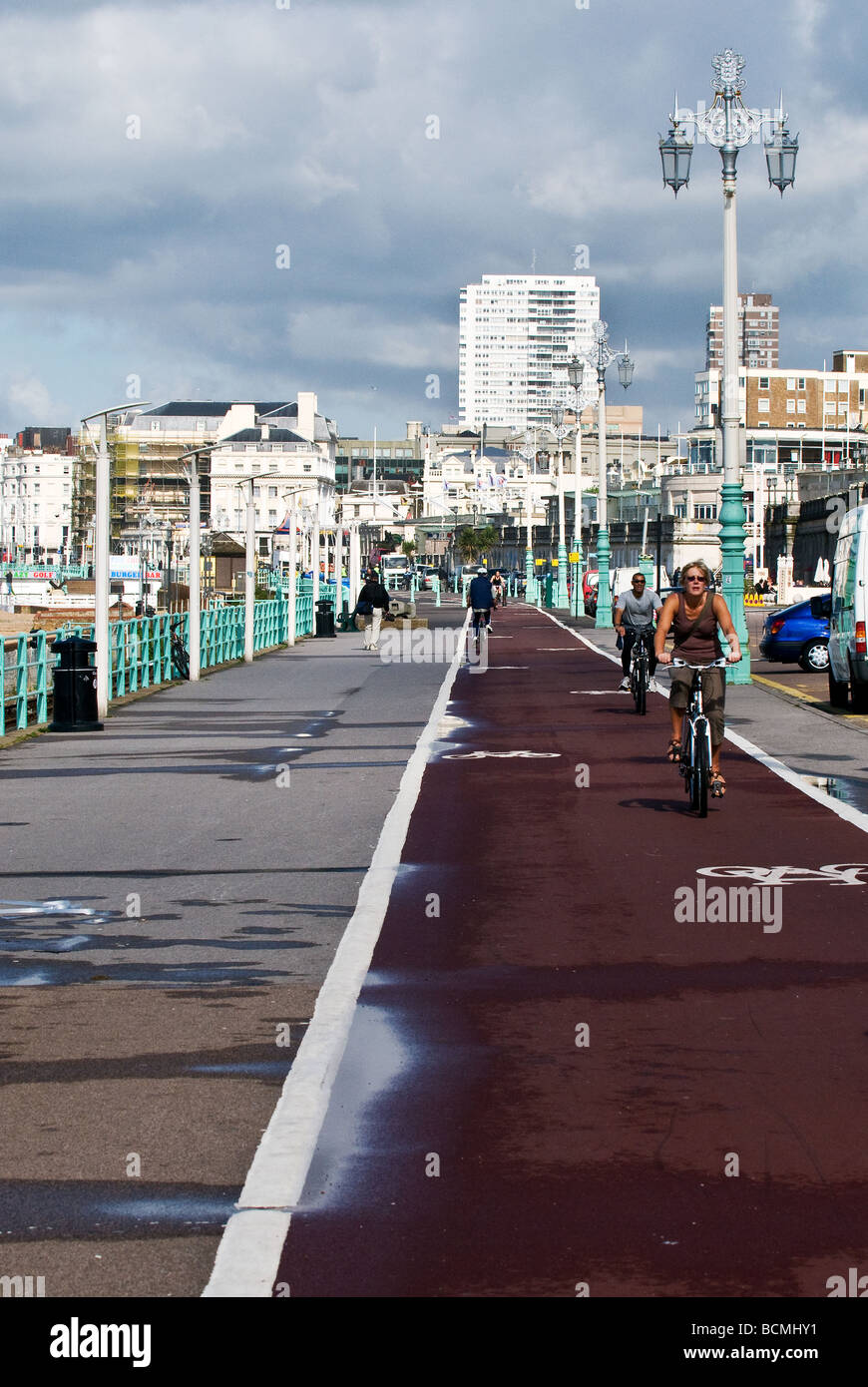 People cycling along the cycle track on Brighton seafront in Sussex ...
