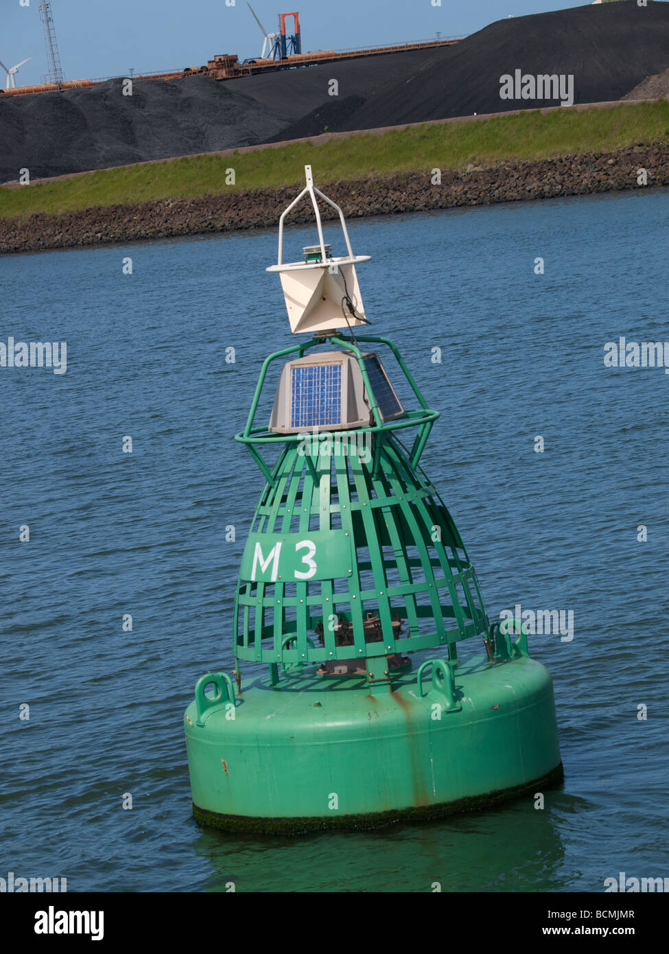 Modern green buoy in the port of Rotterdam marking the shipping lane ...