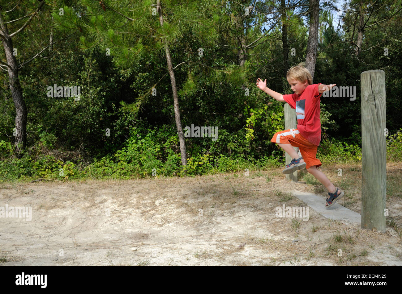Stock photo of a young boy jumping across a long jump pit Stock Photo ...