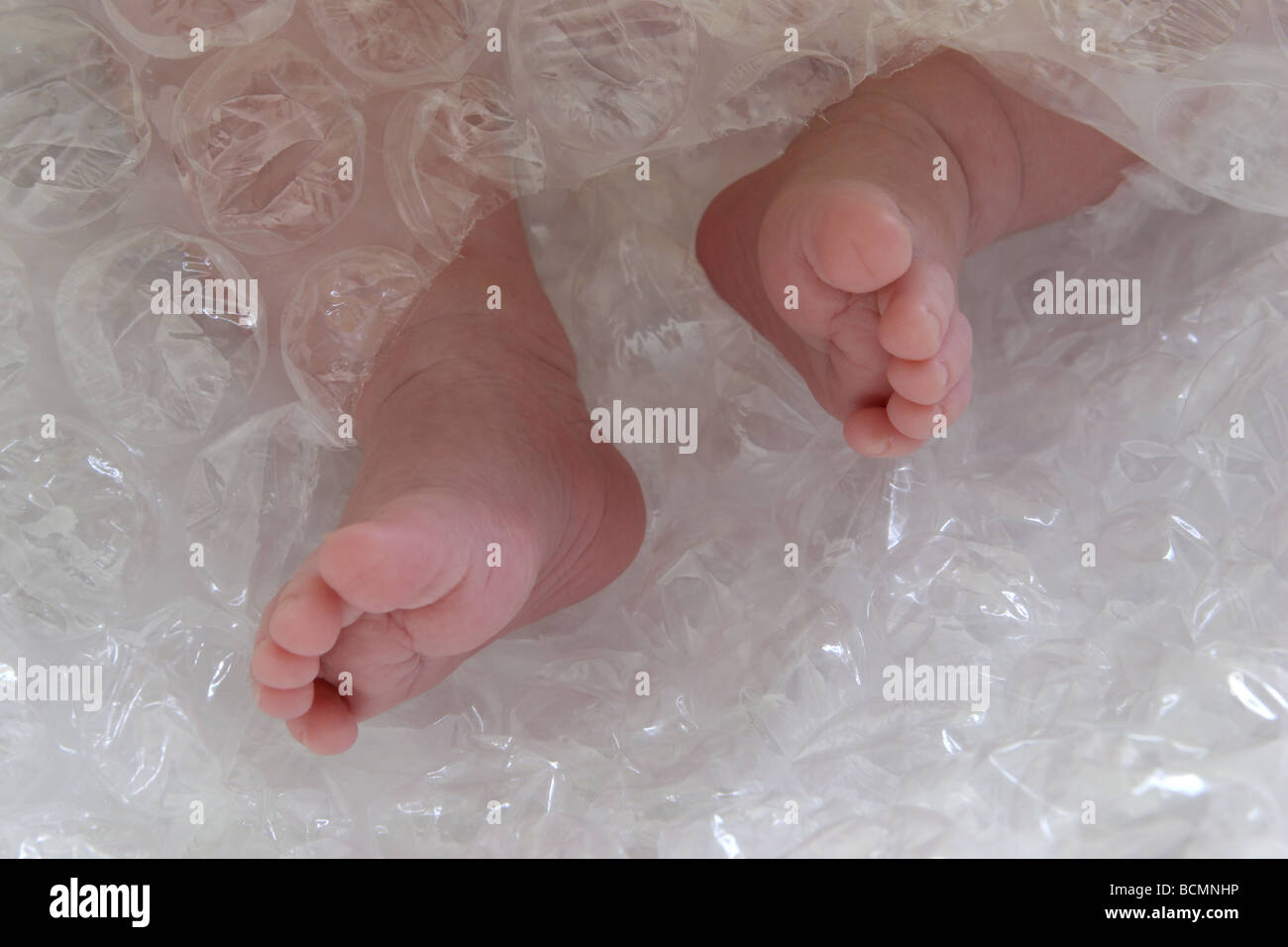Baby Feet wrapped up in Bubble Wrap Stock Photo - Alamy