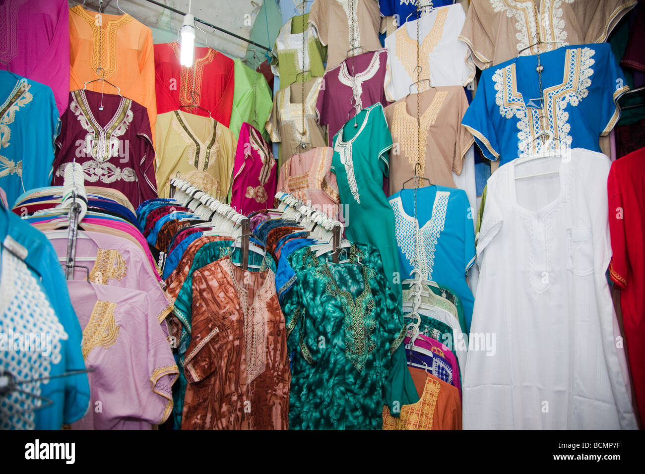 A shop in the Tunis Medina (old city) displays racks of tunics and ...