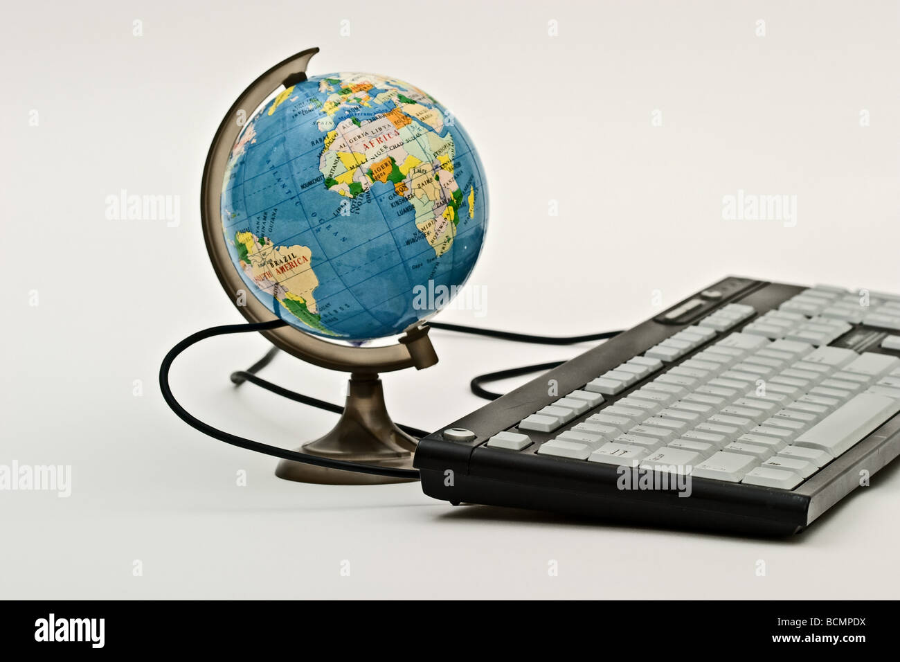 A computer keyboard connected to a globe Stock Photo - Alamy