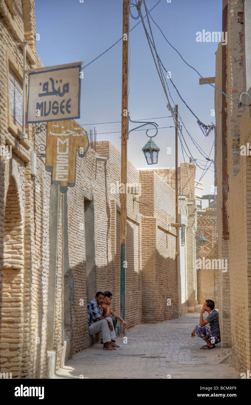 Three men sit in an alley in Tozeur, Tunisia's 14th century Ouled El ...