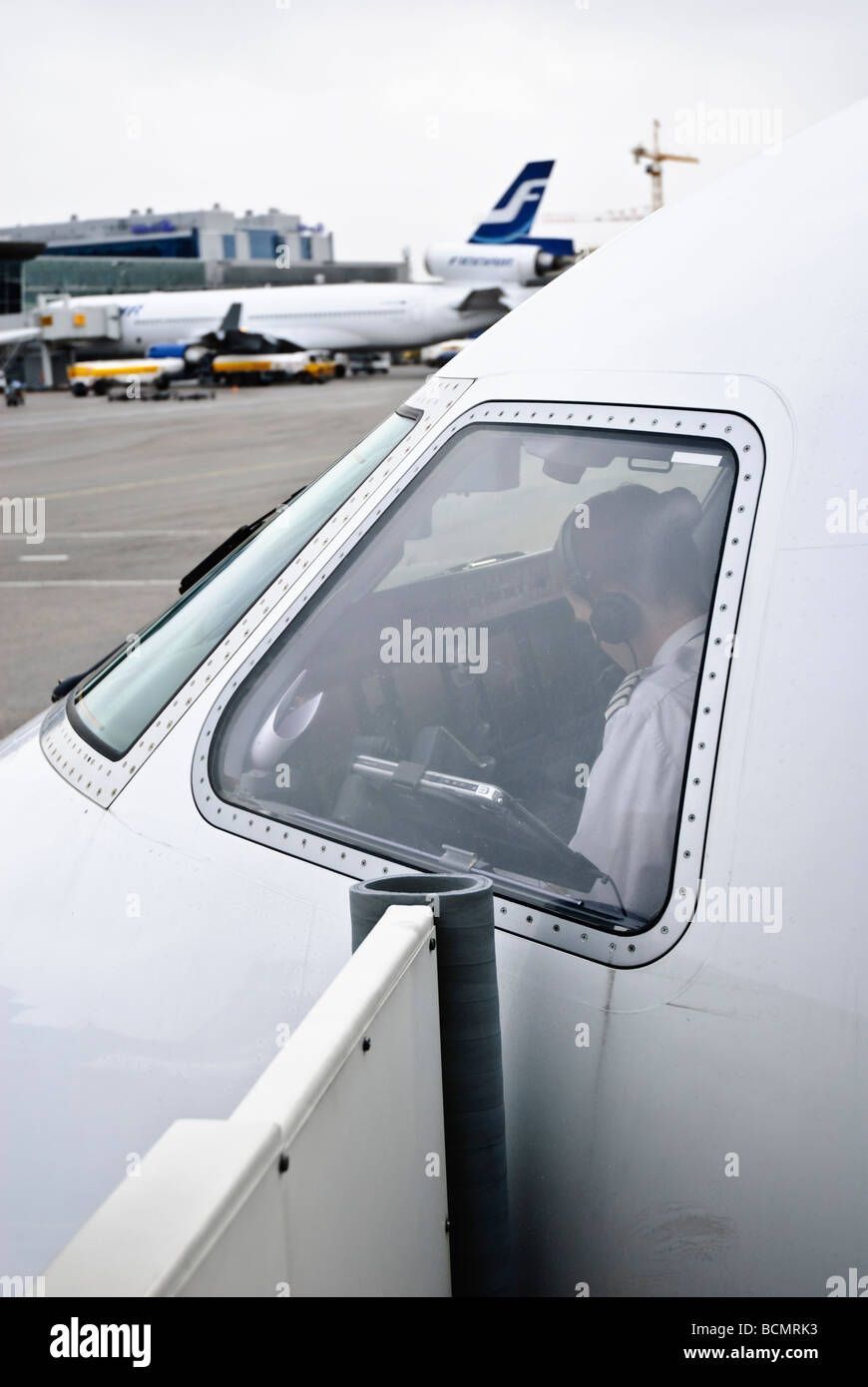 The pilot can be seen preparing for departure through the window of ...