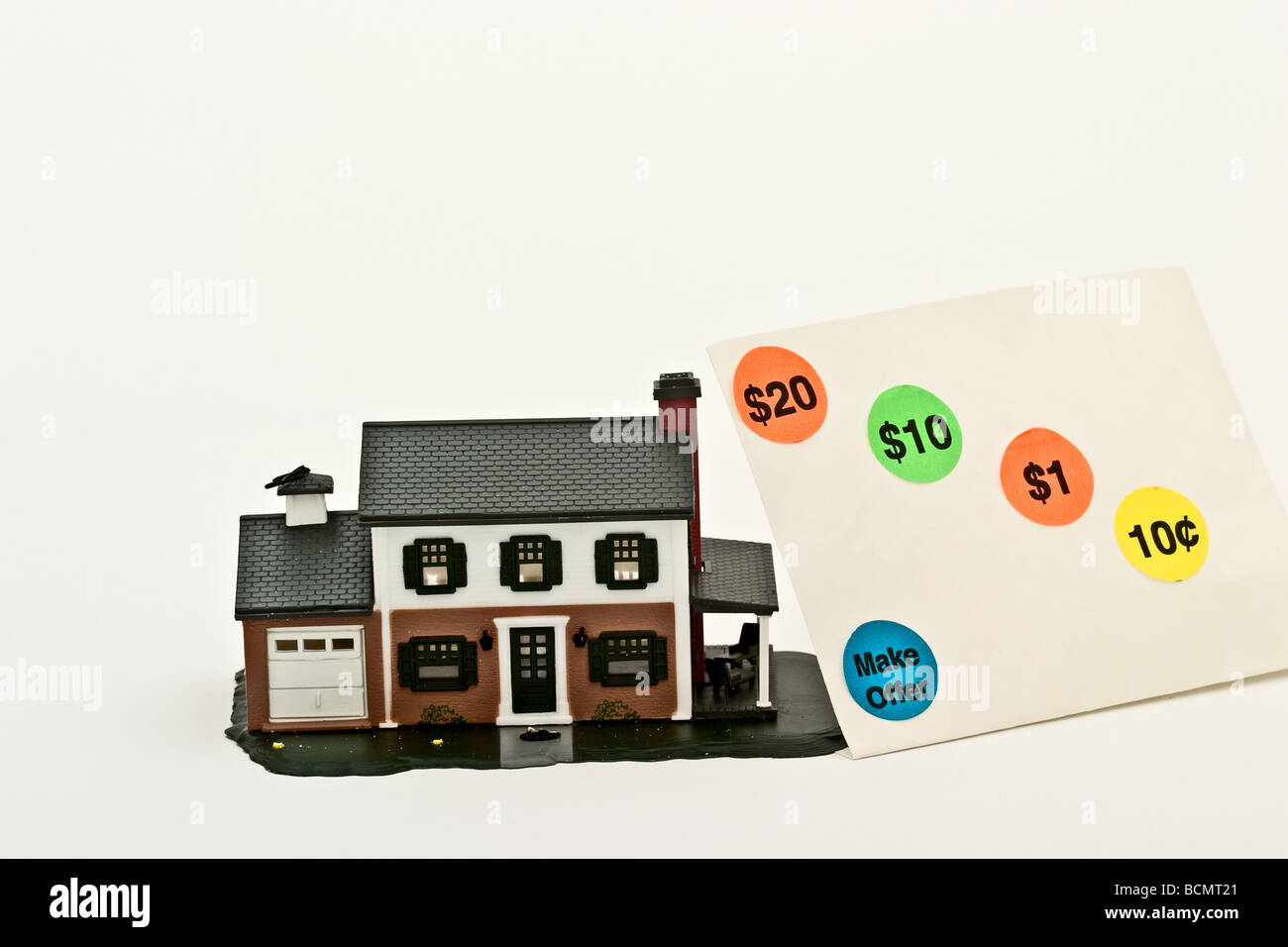 Small plastic house with value stickers next to it Stock Photo - Alamy