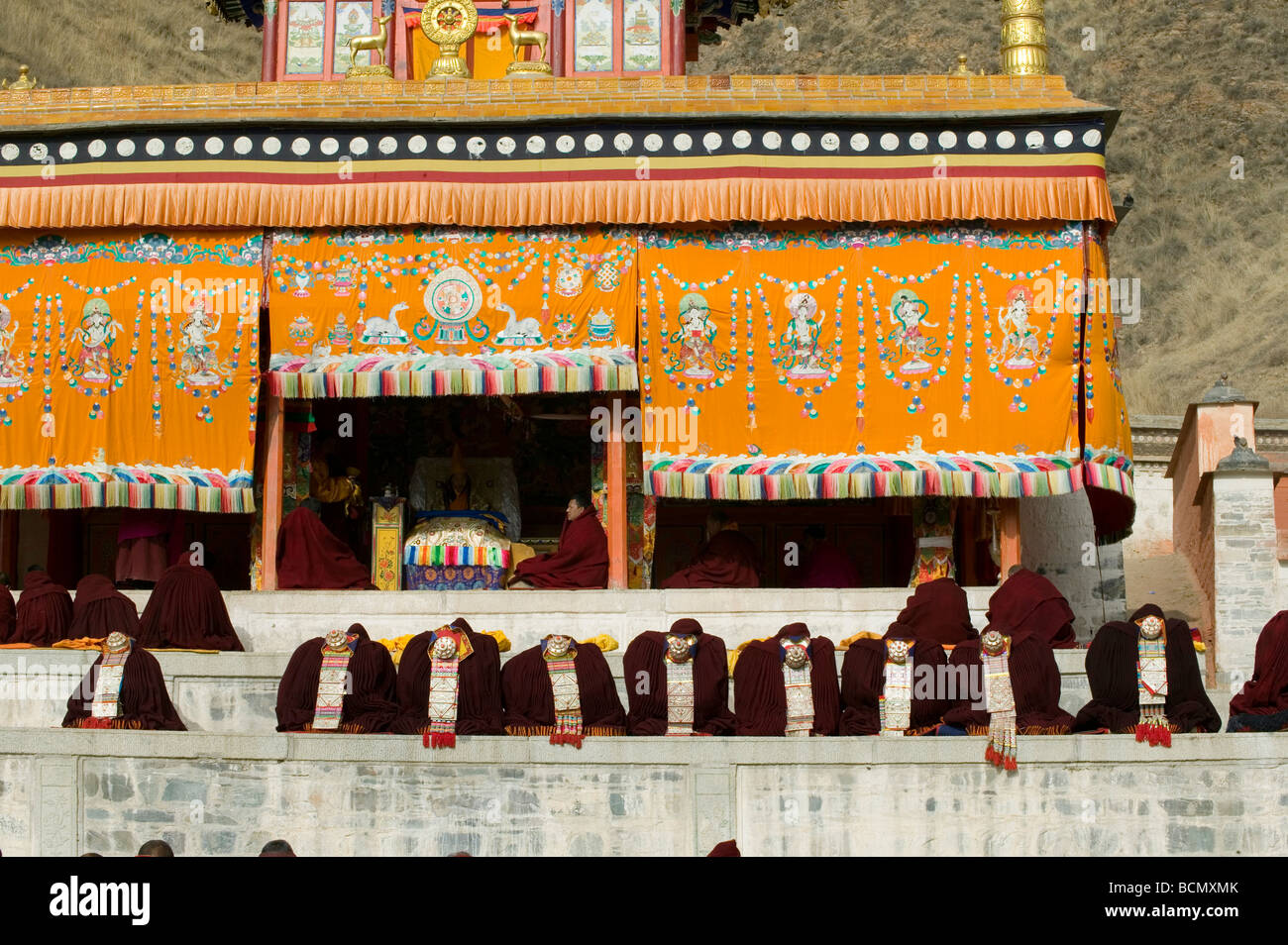 Monks wearing elaborate ceremonial costume in Labrang Monastery, Xiahe ...