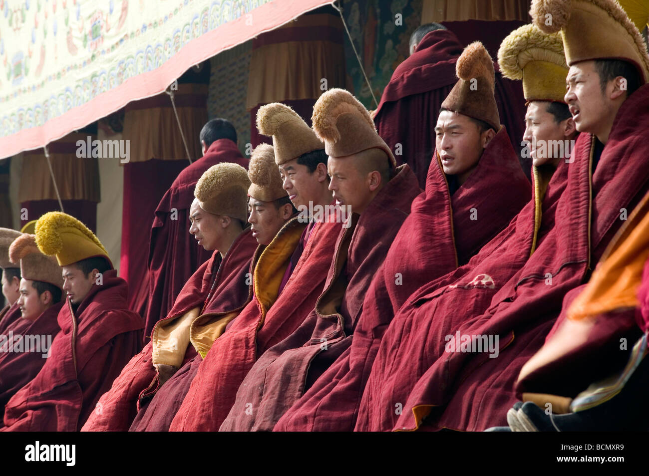Monks wearing elaborate ceremonial costume in Labrang Monastery, Xiahe ...