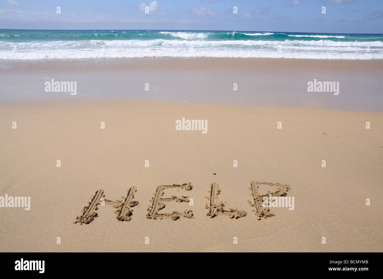 Help written on sand of a tropical beach Stock Photo - Alamy
