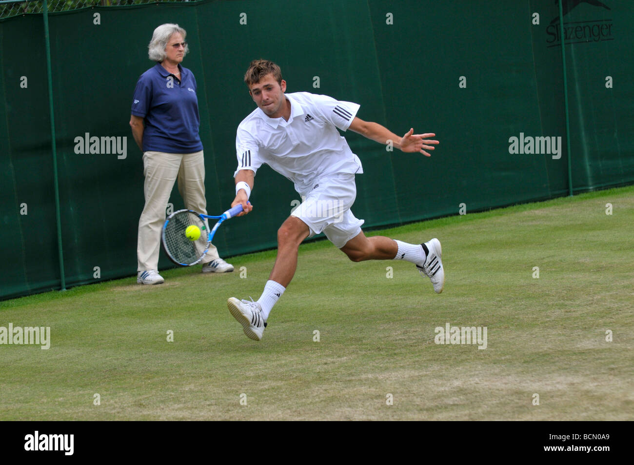 tennis player runs to make forehand return Stock Photo - Alamy