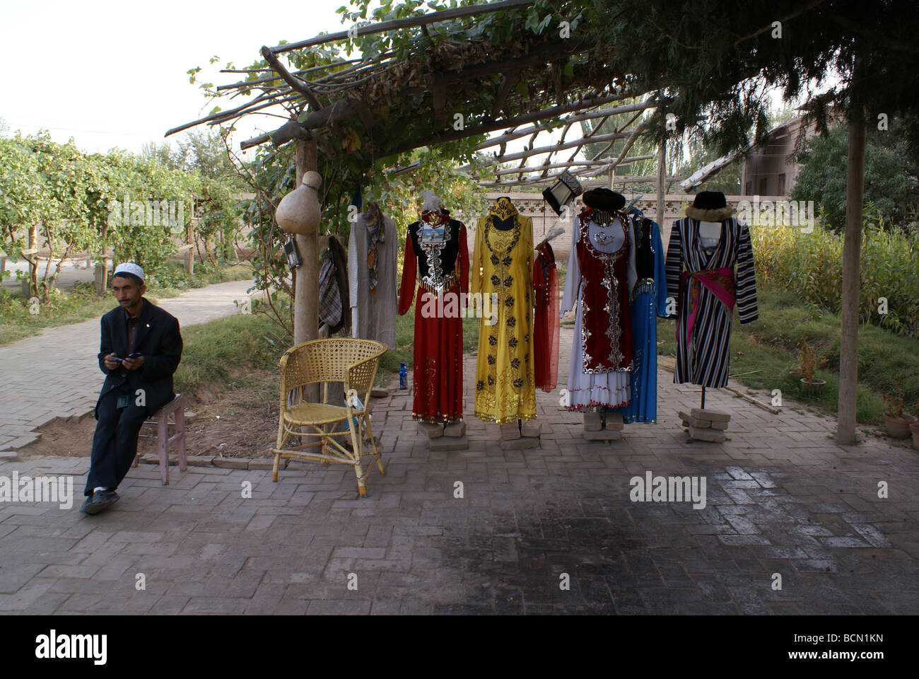 Streeside stall selling elaborate Uyghur costumes, Kashgar, Kashgar ...