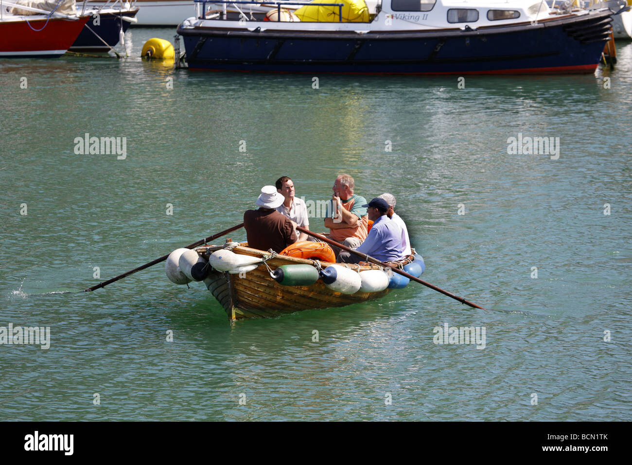 Five people in a rowing boat Stock Photo - Alamy
