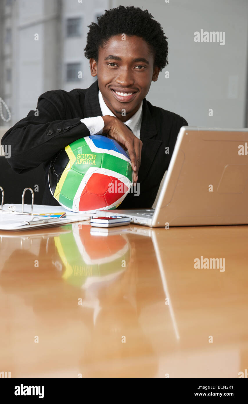Businessman smiling sitting at his desk in office environment Stock ...