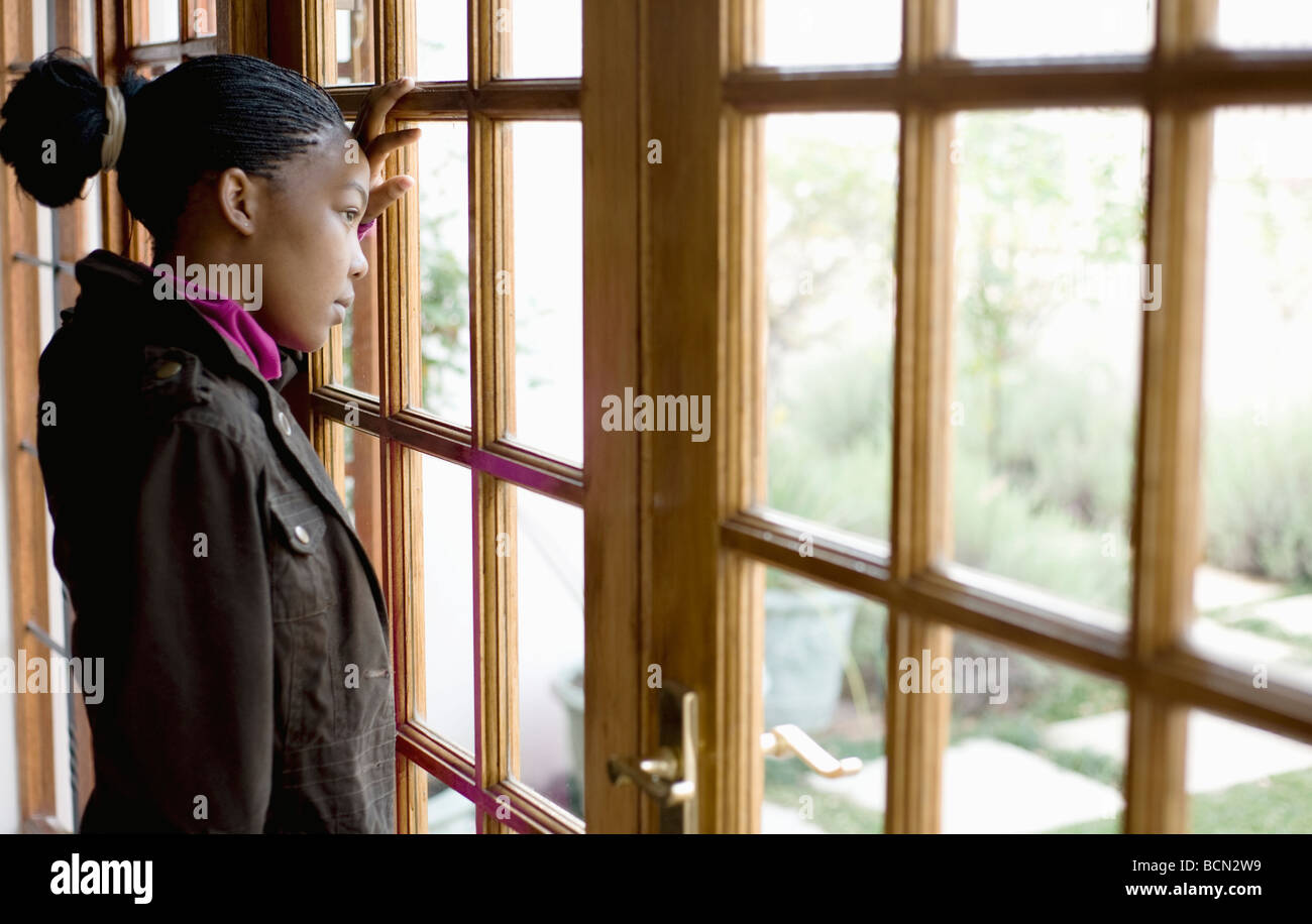 A young woman stares longingly out of the window Stock Photo - Alamy