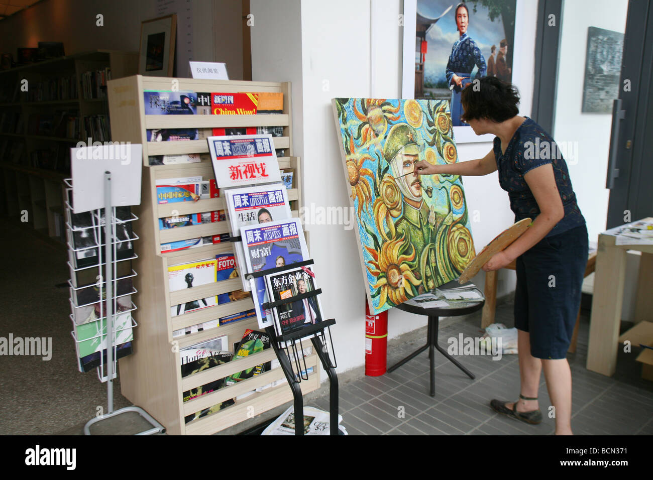 Artist creating oil painting of Vicent van Gogh wearing Maoist uniform ...