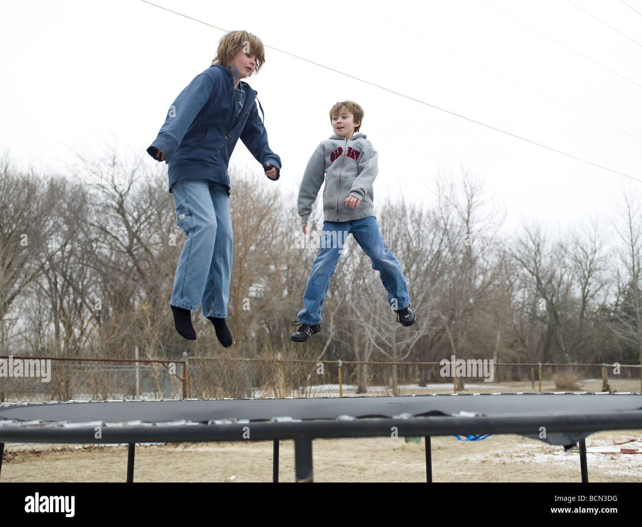 Two boys playing on trampoline hi-res stock photography and images - Alamy