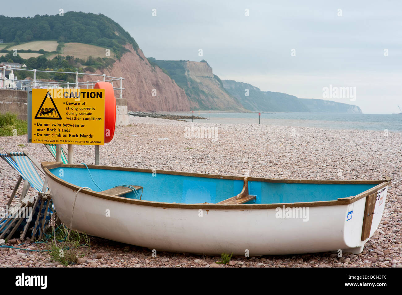 Boat and warning sign on the beach at Sidmouth in Devon Stock Photo - Alamy
