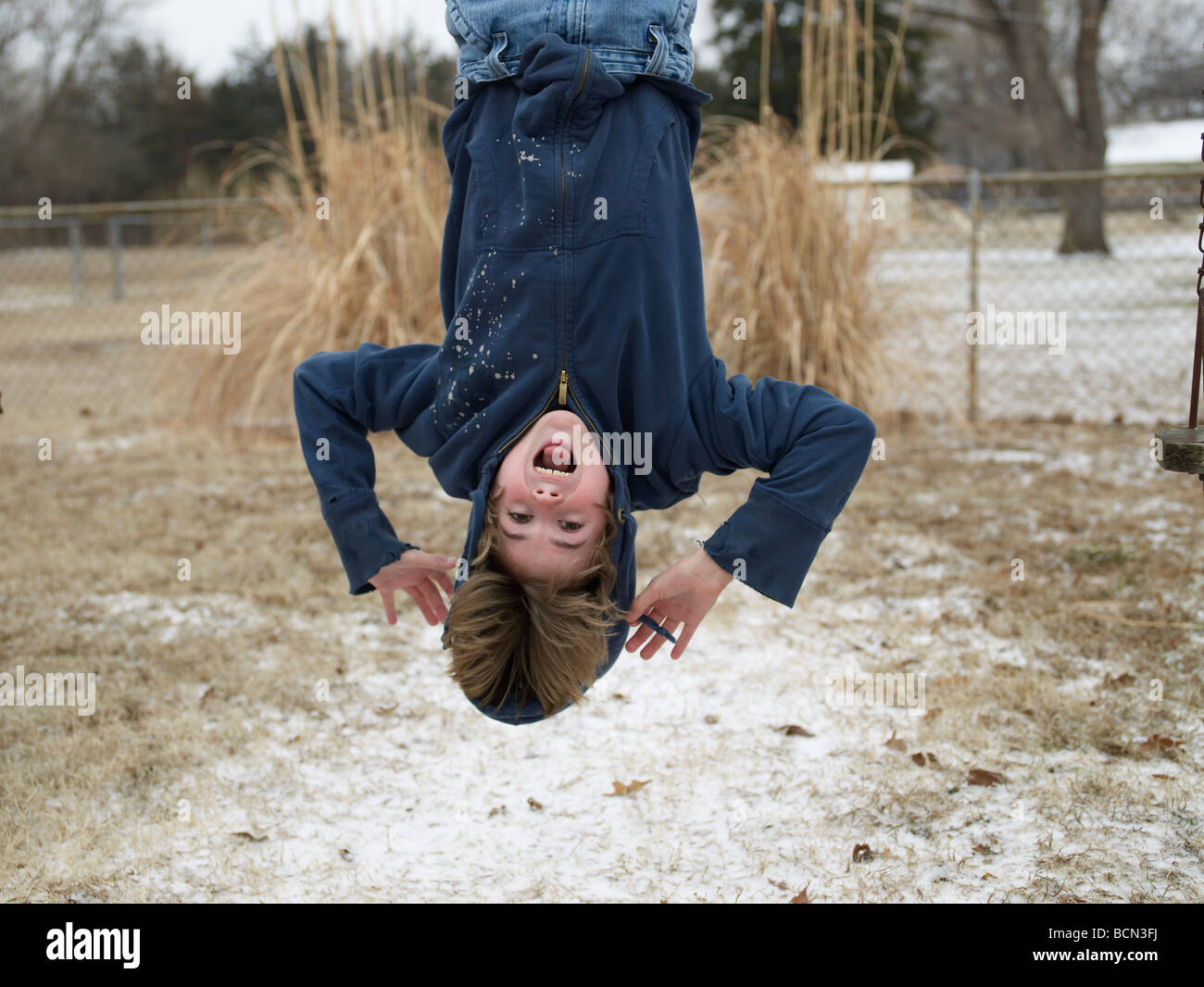 Boy Hanging Upside Down Stock Photo - Alamy