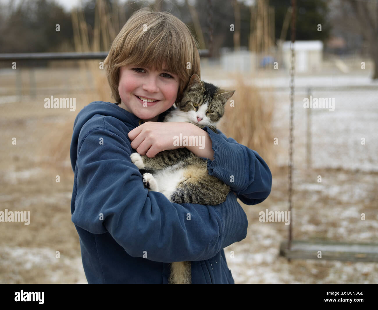 Boy holding pet cat hi-res stock photography and images - Alamy