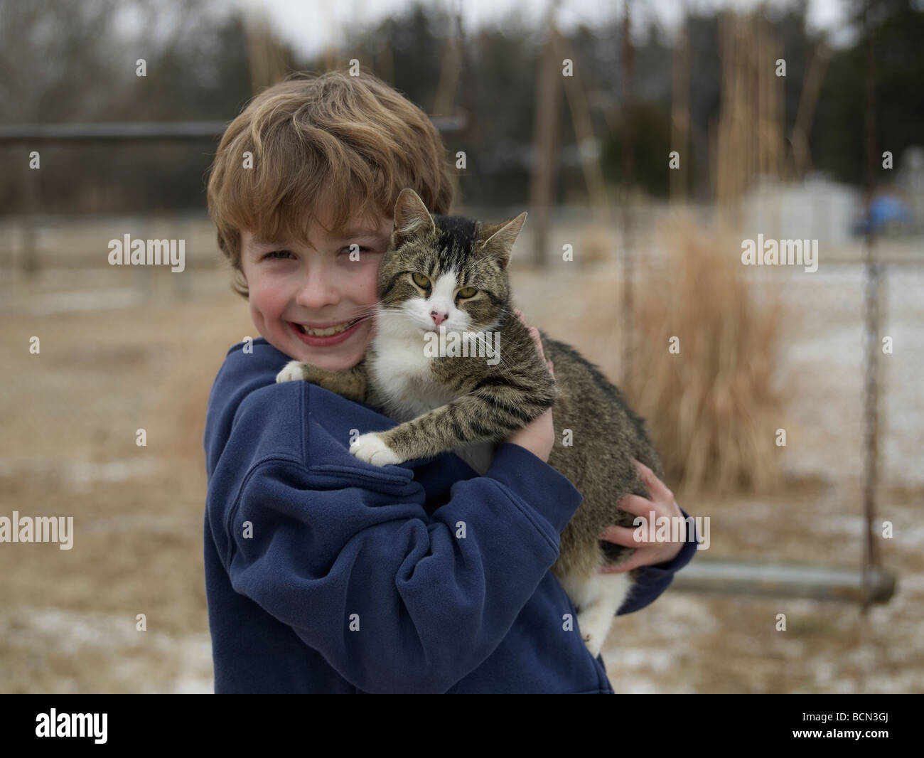 Portrait of Boy Holding Cat Stock Photo - Alamy
