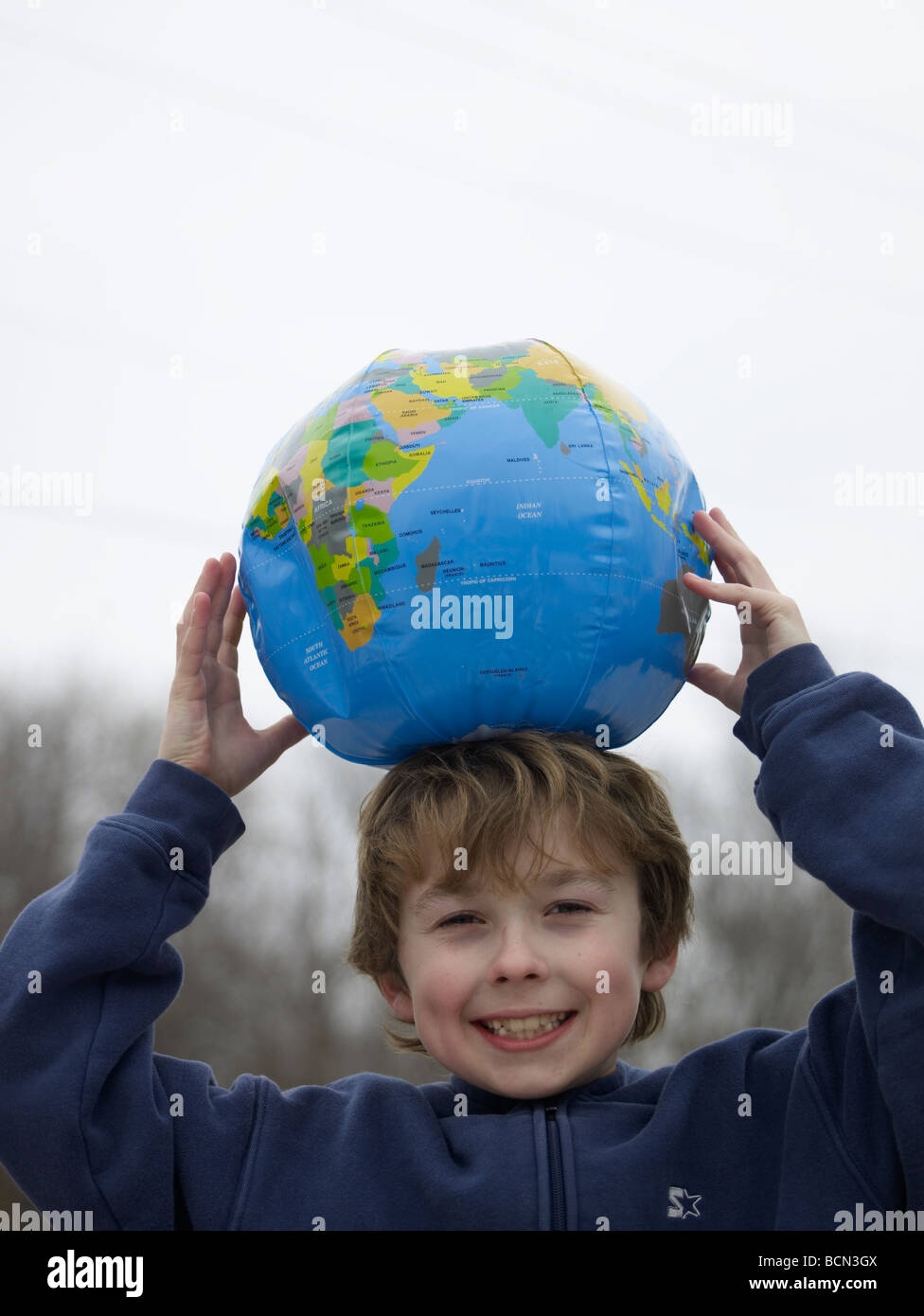 Boy With Globe On Top Of Head Stock Photo - Alamy