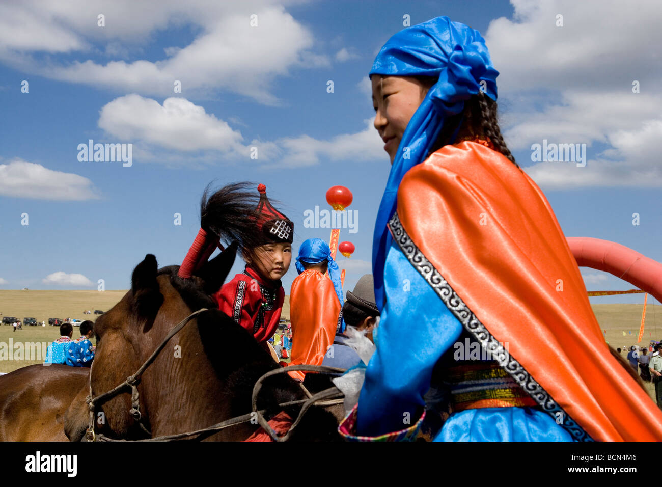 Young Mongolian girls getting ready for horse race during Naadam ...