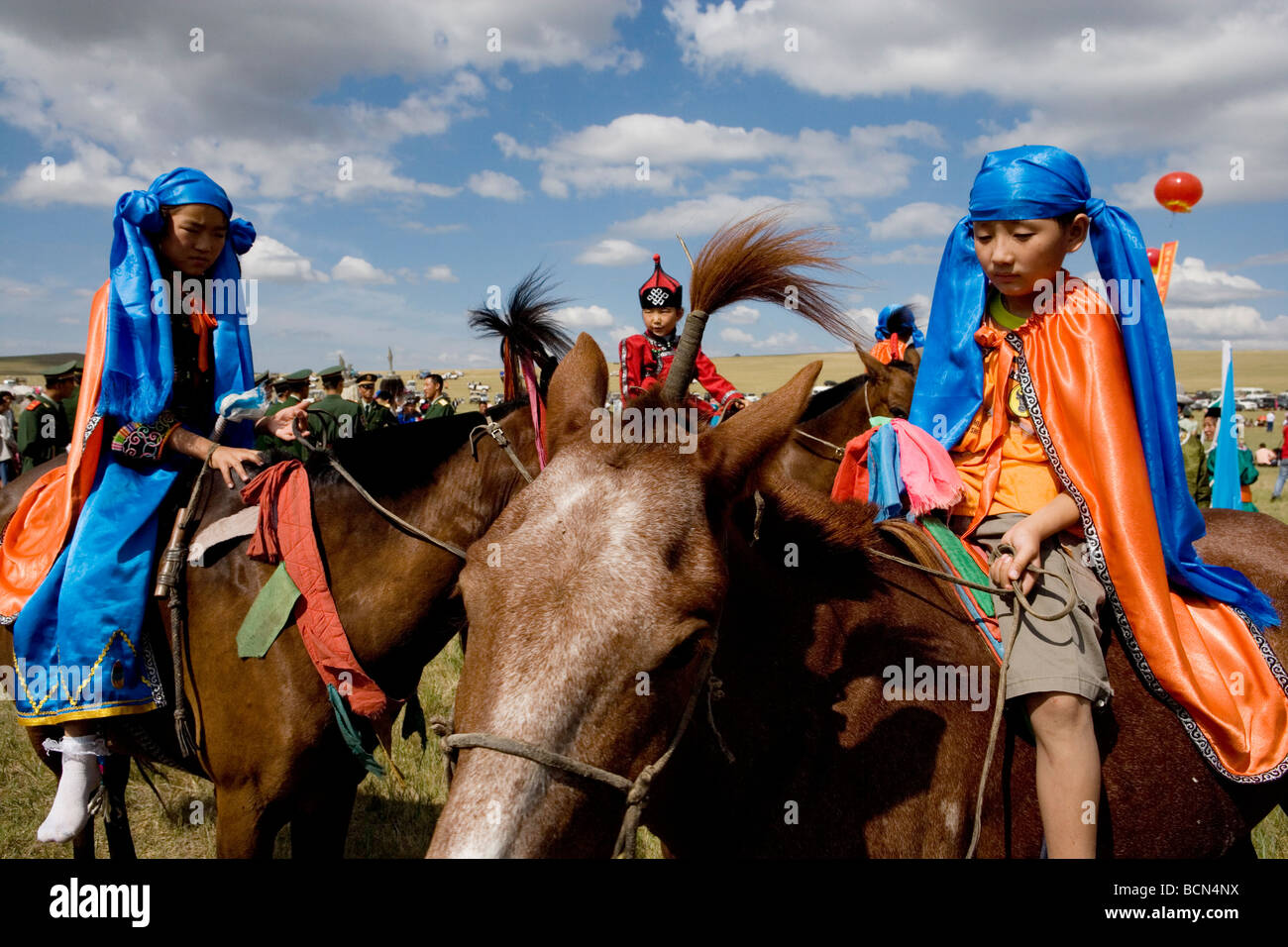 Young Mongolian girls getting ready for horse race during Naadam ...