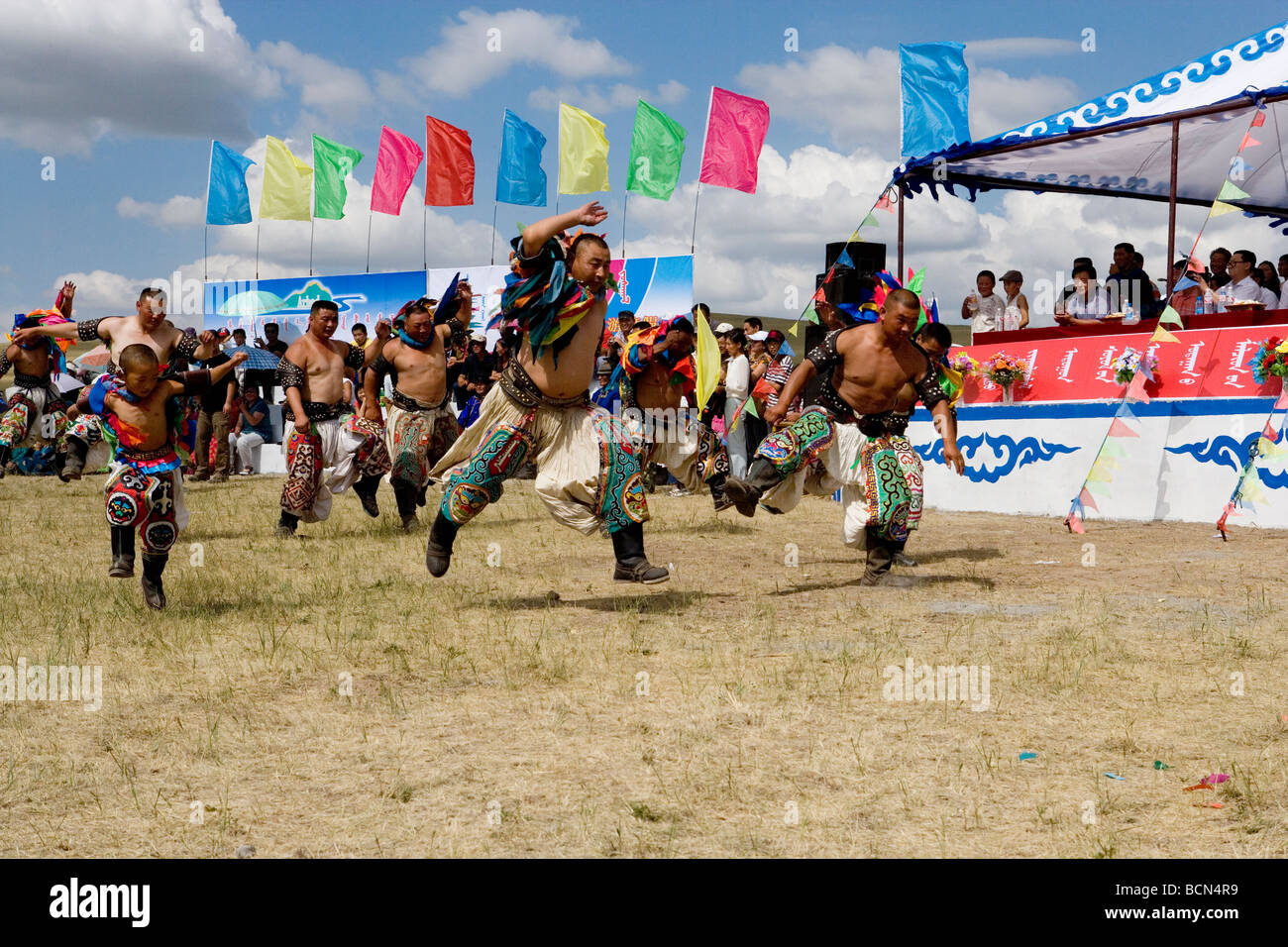 Mongolian wrestlers performing dance ritual during Naadam Festival ...