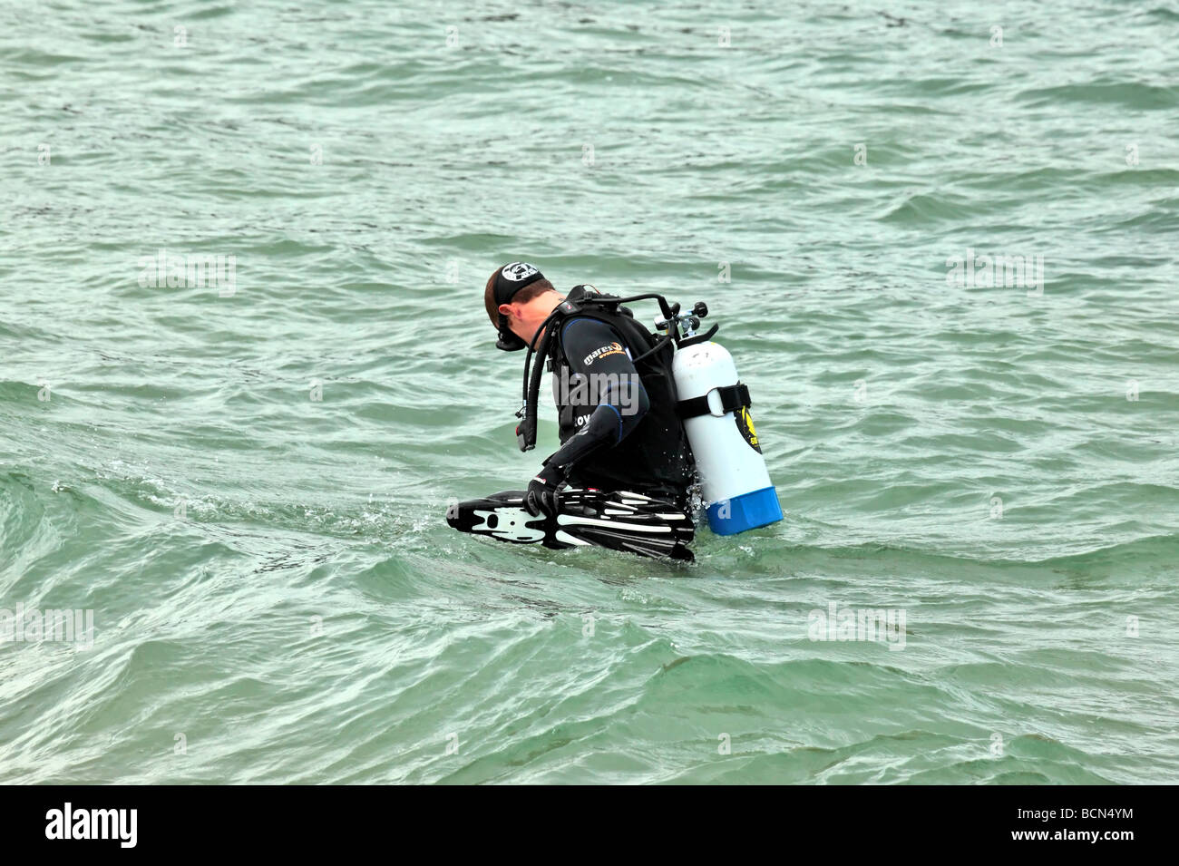 Scuba diver prepares for a beach entry into the ocean Stock Photo - Alamy
