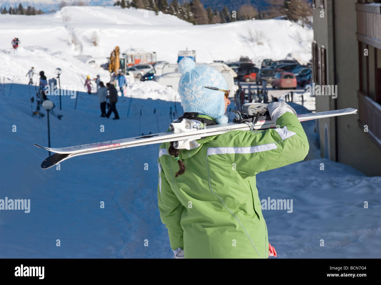 woman carrying skies over shoulders in Passo del Tonale Trentino Italy ...
