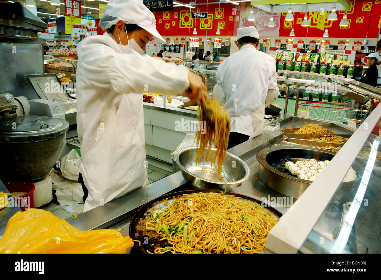 Service person making noodles in local supermarket, Shanghai, China ...
