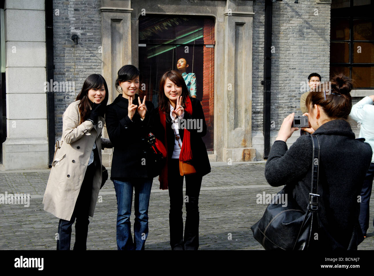 Three Asian young woman posing for photo in Shanghai Xintiandi Shopping ...