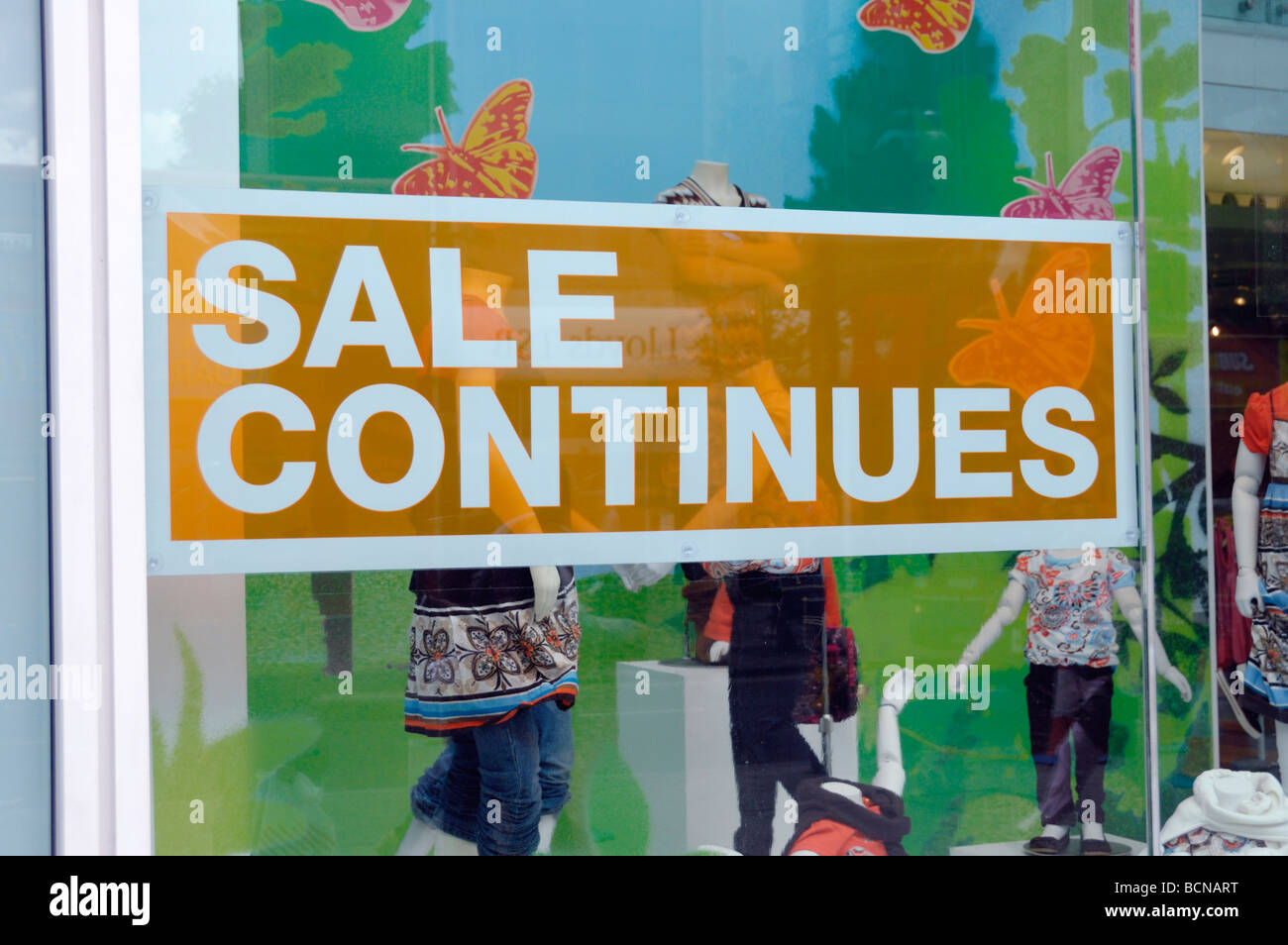Sale Continues sign in shop window Stock Photo - Alamy
