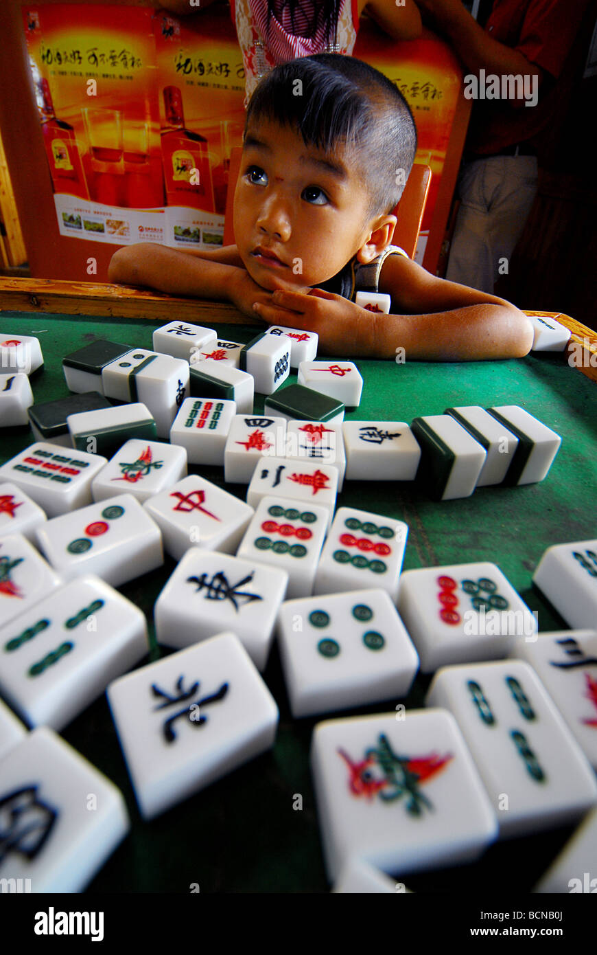 Boy beside a mahjong table hi-res stock photography and images - Alamy