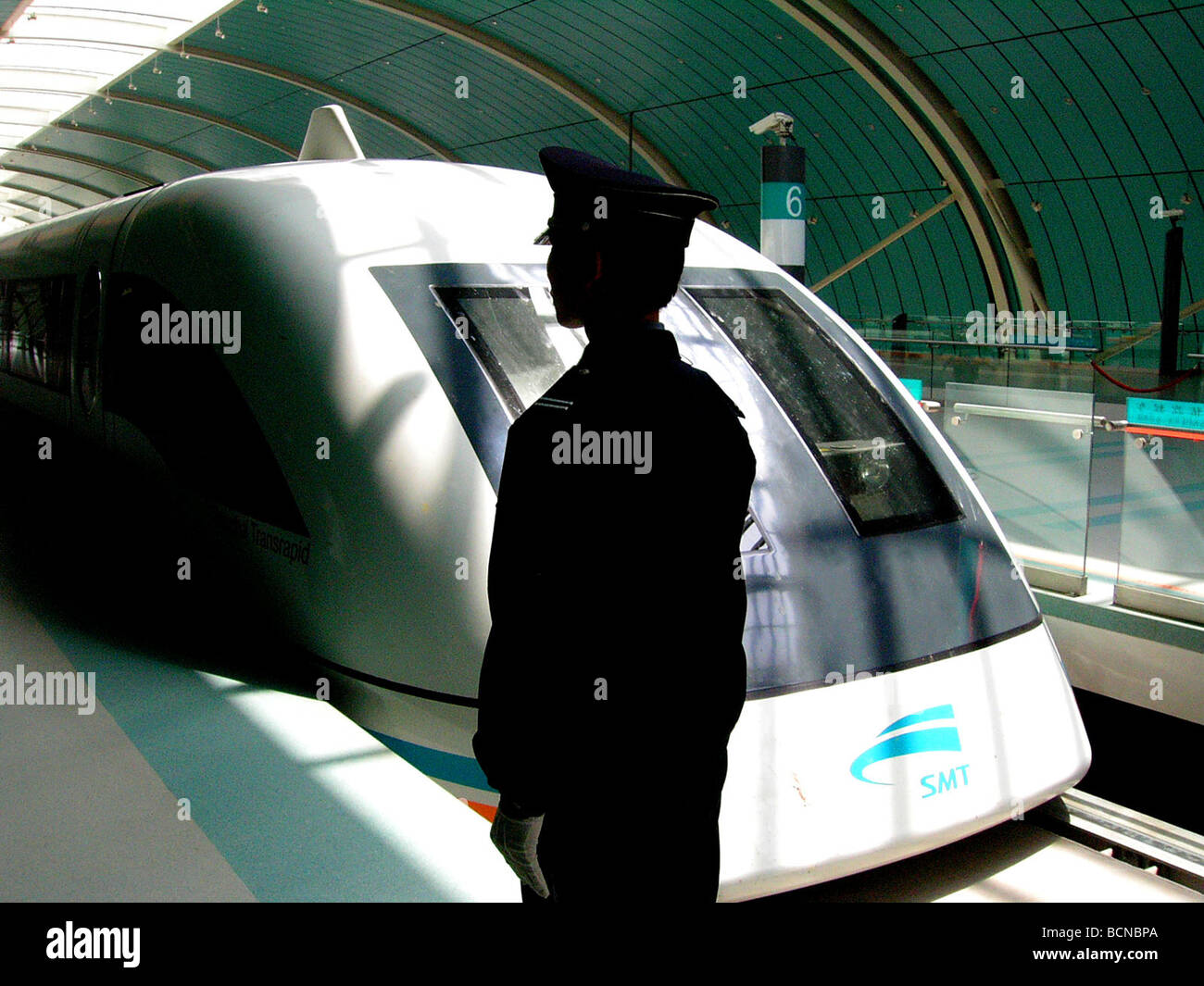 Security guard standing beside Maglev train in the train station ...