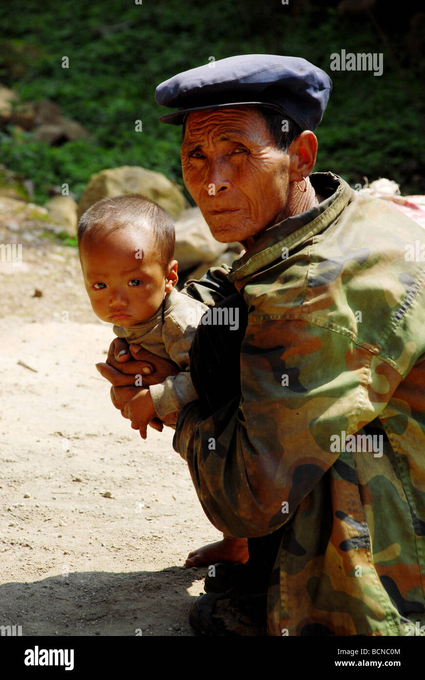 Yi minority father and child, Liangshan Yi Autonomous Prefecture ...