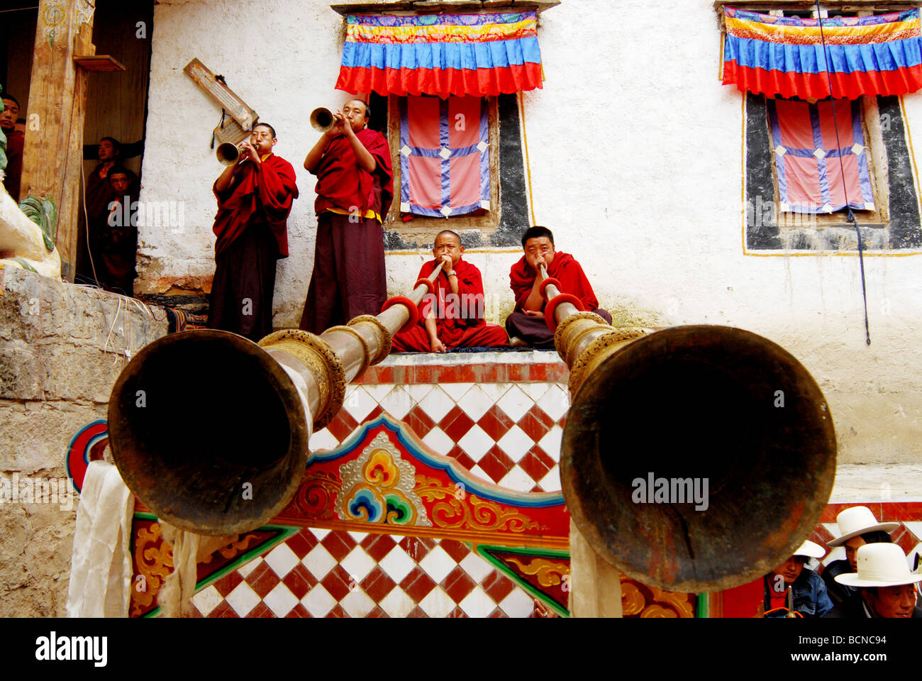 Lamas playing giant trumpet during Cham Ceremony, Riku Gonpa, Kangding ...